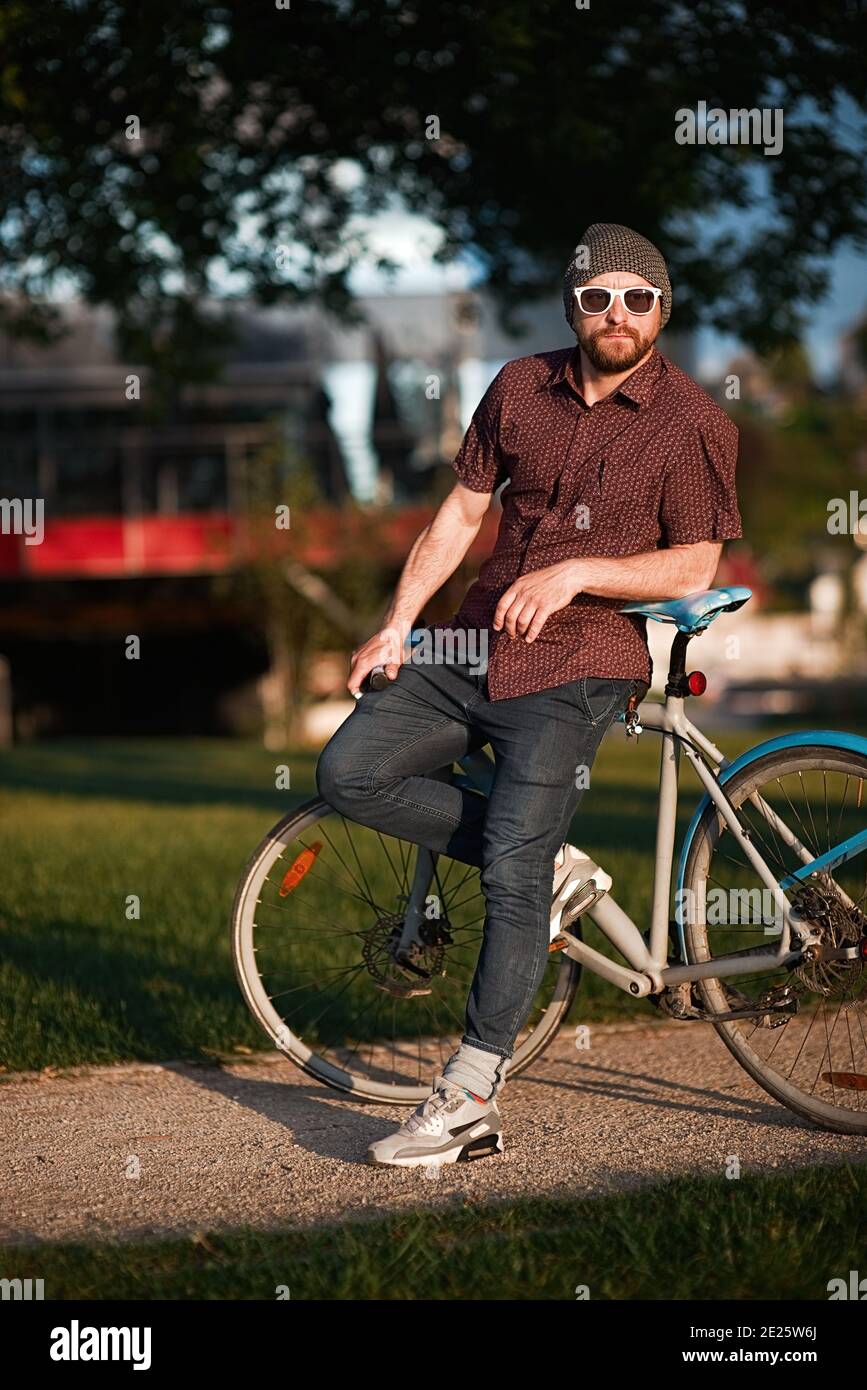 A handsome male with bicycle and backpack Stock Photo - Alamy