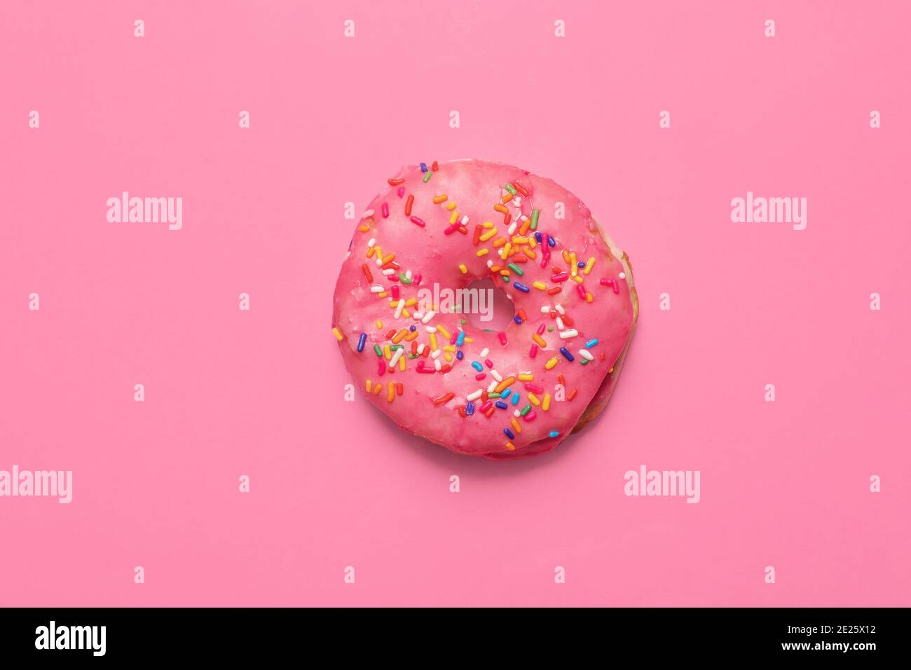single pink donut doughnut on a matching pink background with pink ...