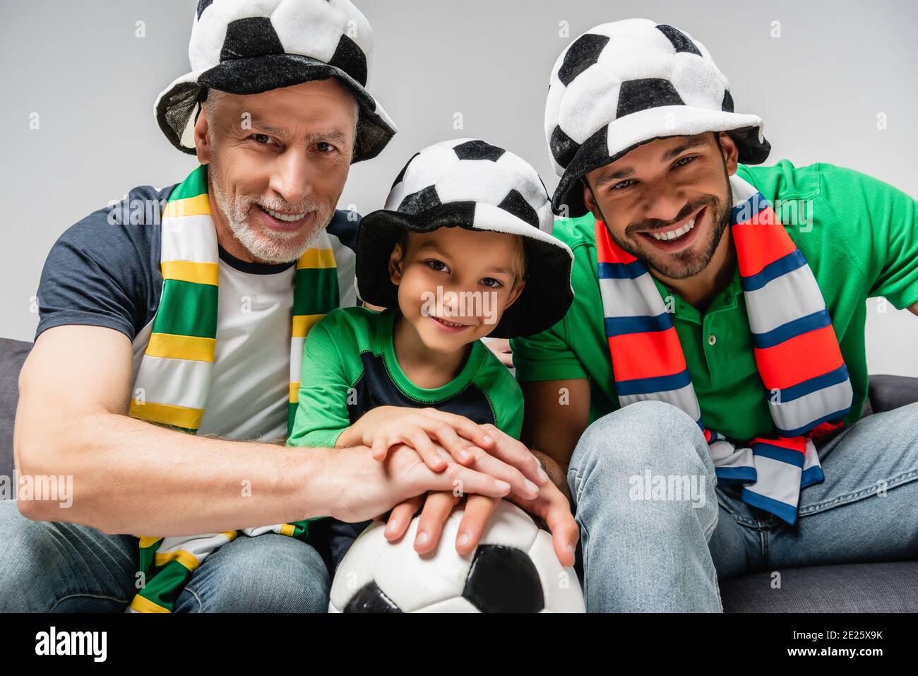 happy men and boy in fan hats watching football championship isolated ...