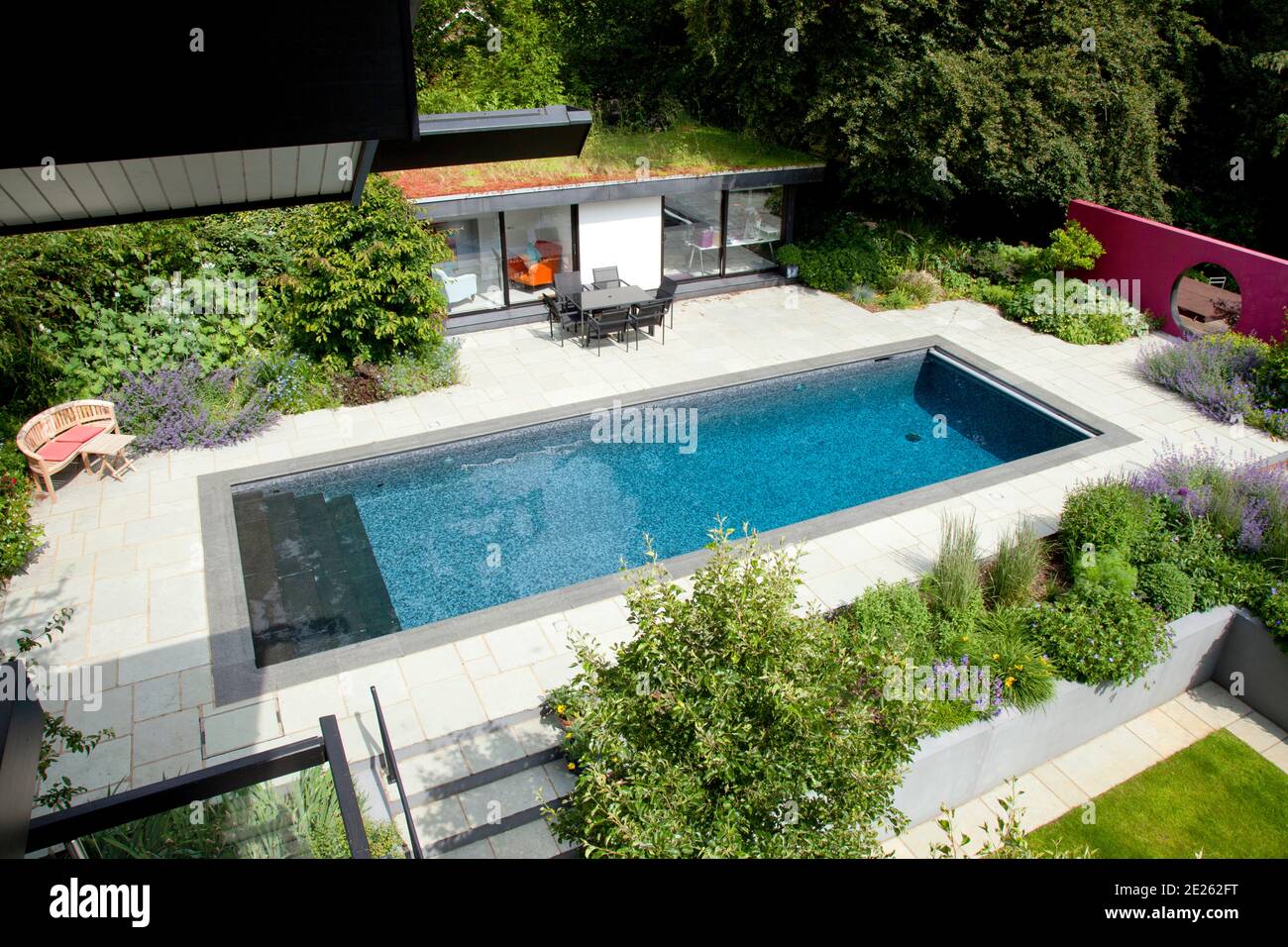 Overview of contemporary private outdoor rectangular pool with garden ...