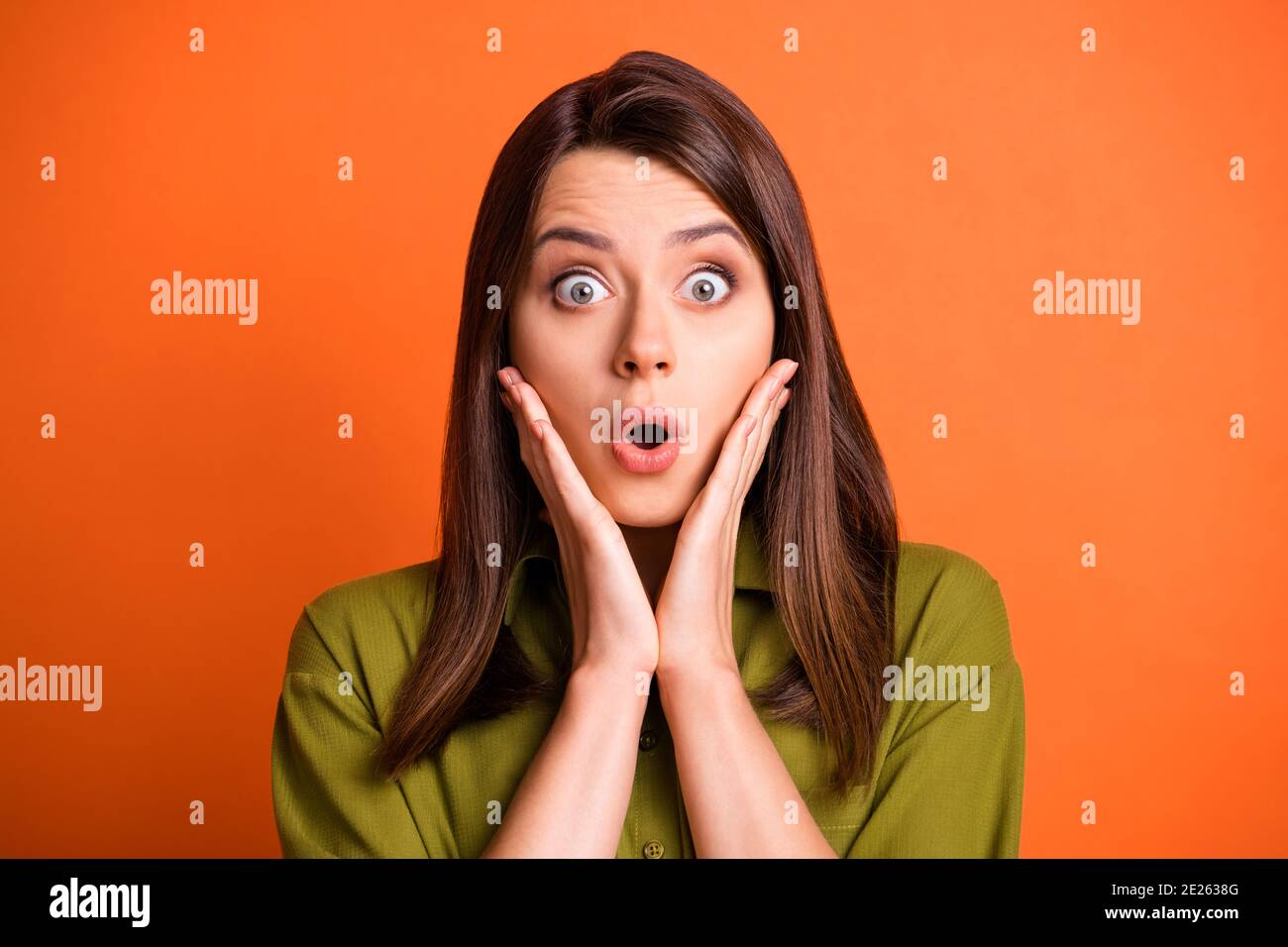 Photo of adorable shocked girl palms cheeks open mouth look camera wear ...