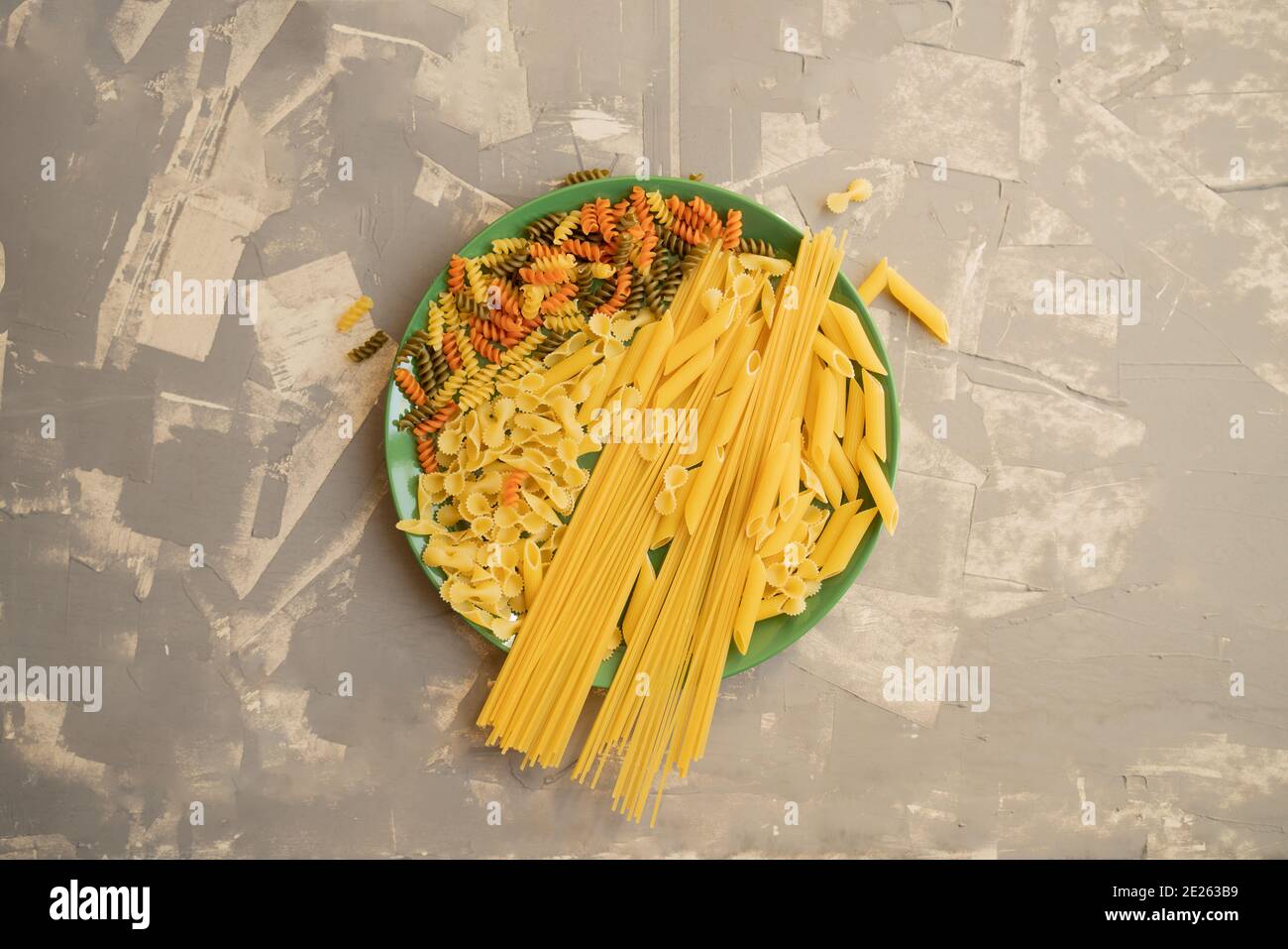 spaghetti and different types of pasta colorful pastas on textured ...