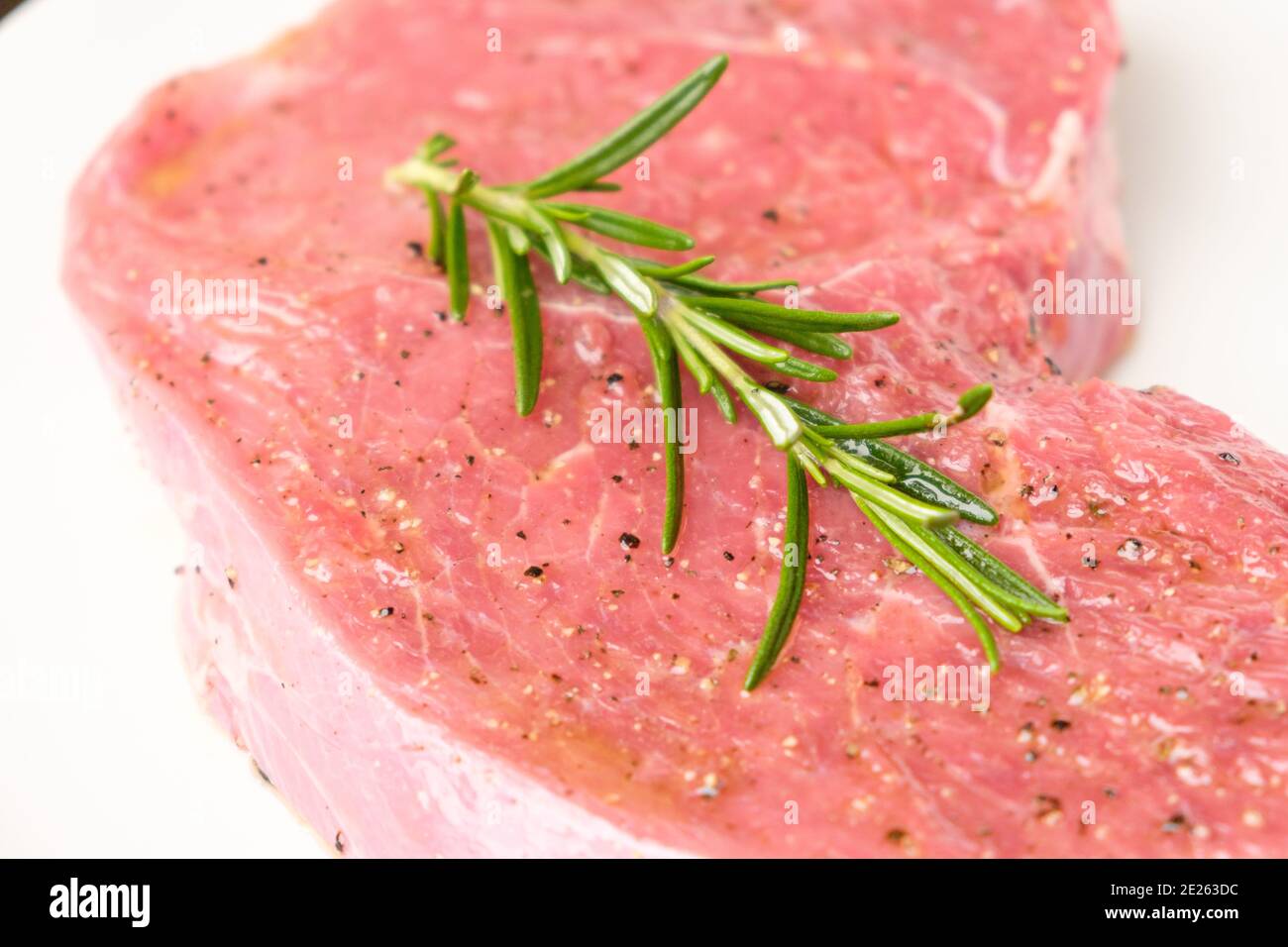 Raw beef steak meat with branch of rosemary and species isolated on a ...