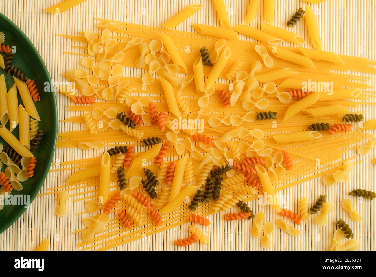 spaghetti and different types of pasta colorful pastas on wooden line ...