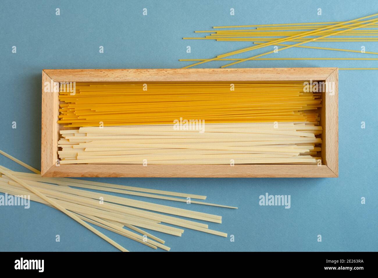 spaghetti and tagliatelle line on light blue background. pasta in a ...