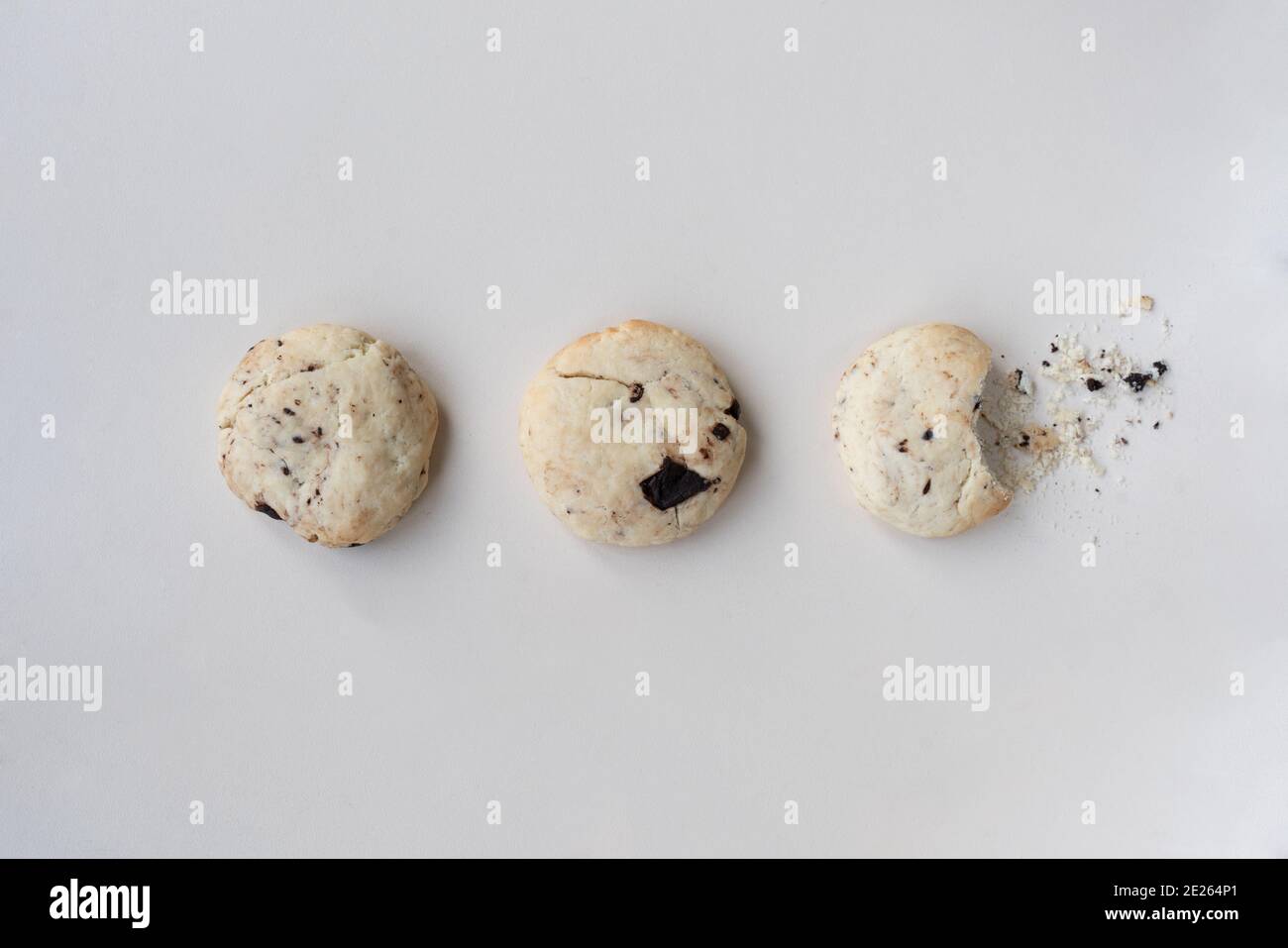 chocolate chip cookies standing next to each other on white background ...
