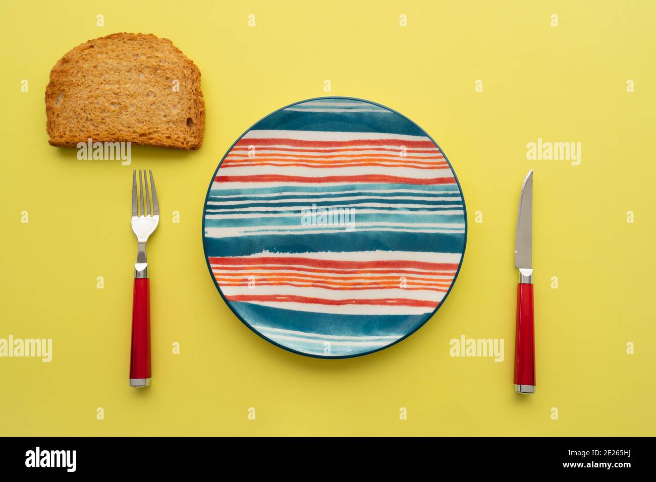 breakfast table empty colorful plate, toasted bread on yellow ...