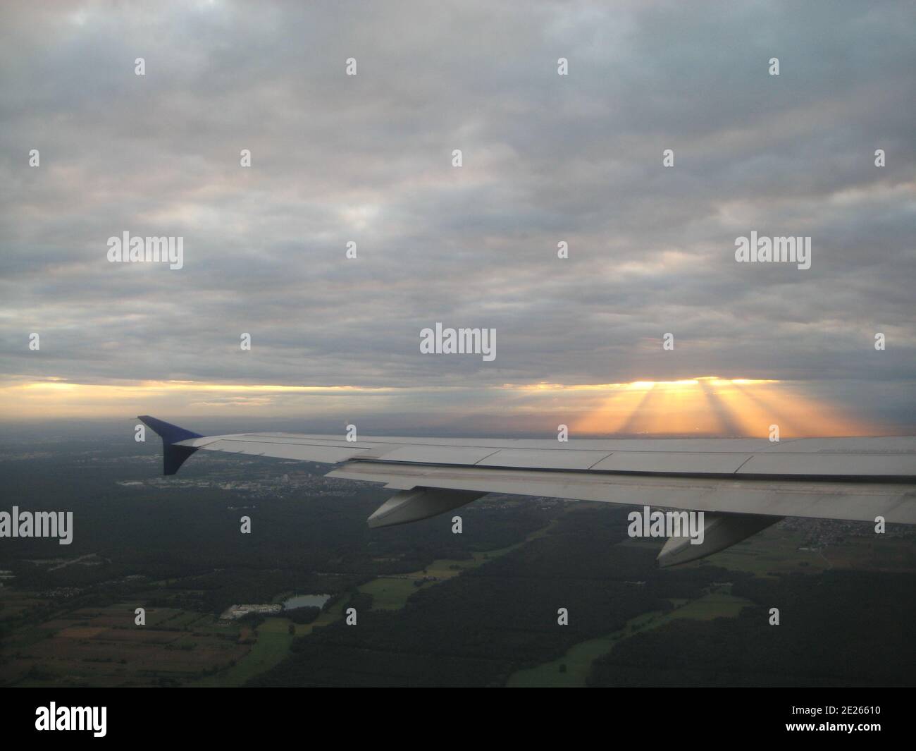 sunset between clouds from above out of a plane window Stock Photo - Alamy