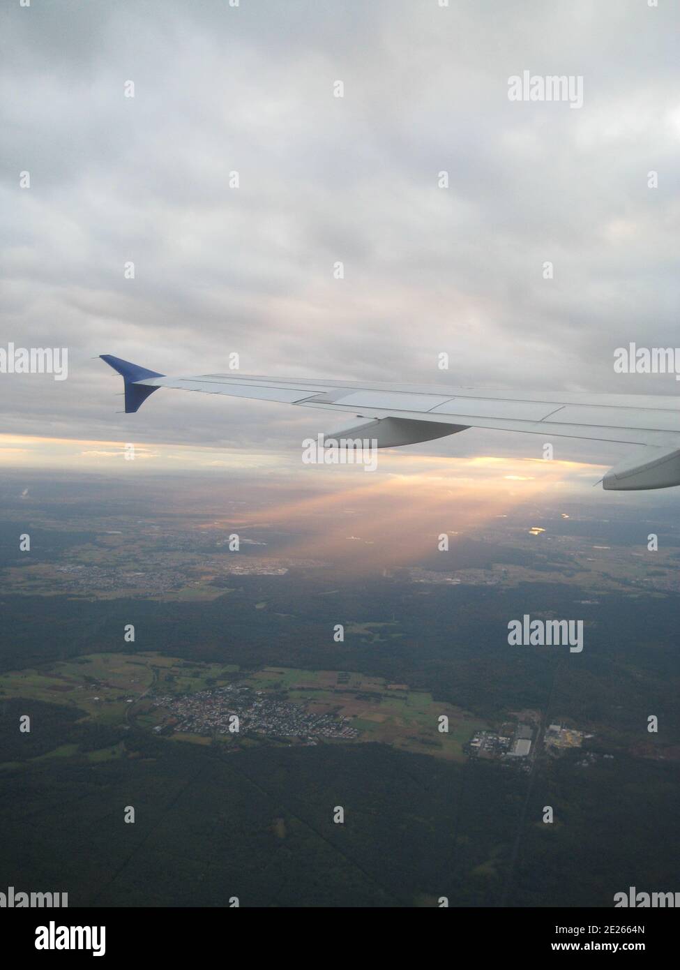 sunset between clouds from above out of a plane window Stock Photo - Alamy