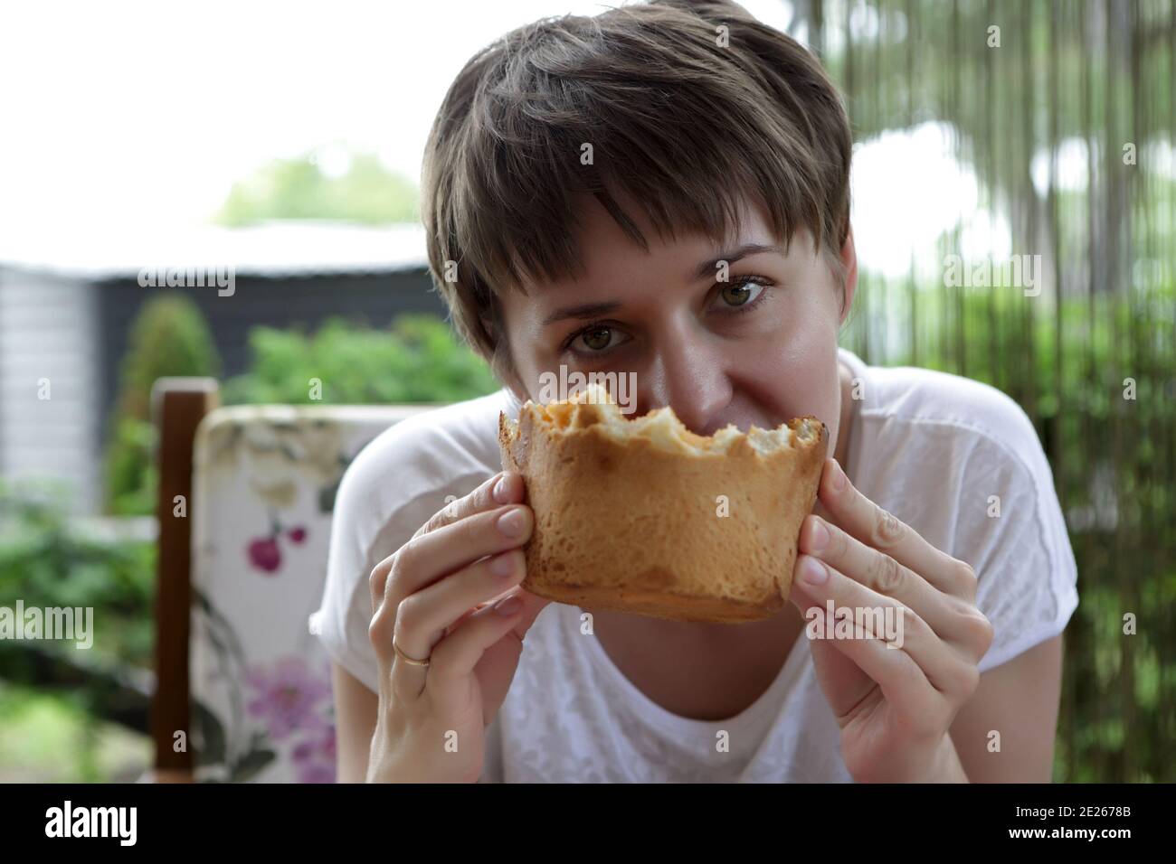Woman biting bread plate for soup in cafe Stock Photo - Alamy