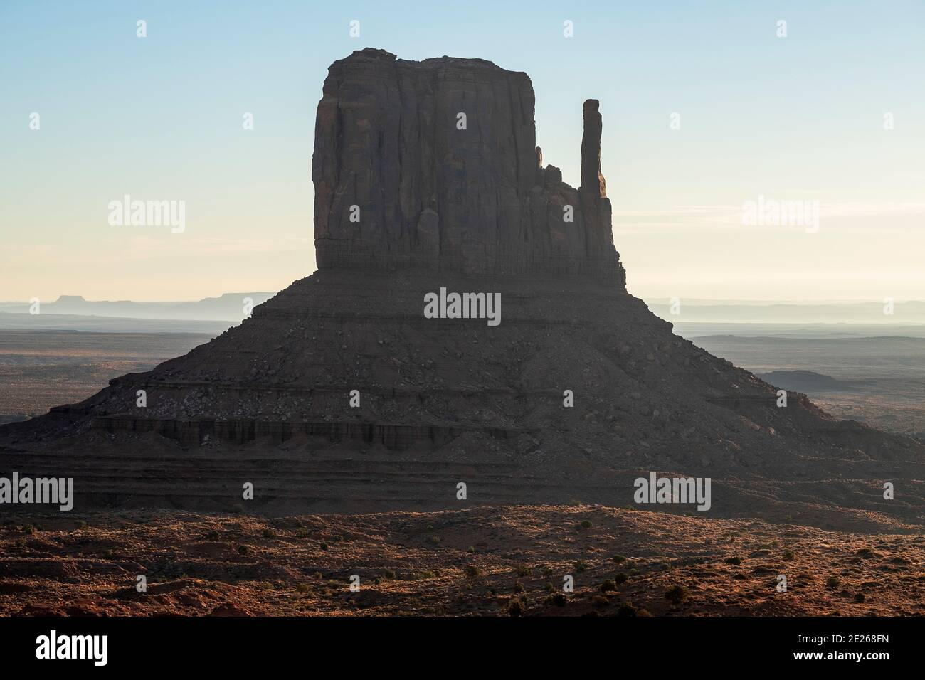 Dawn light with the silhouette of the iconic West Mitten rock formation ...
