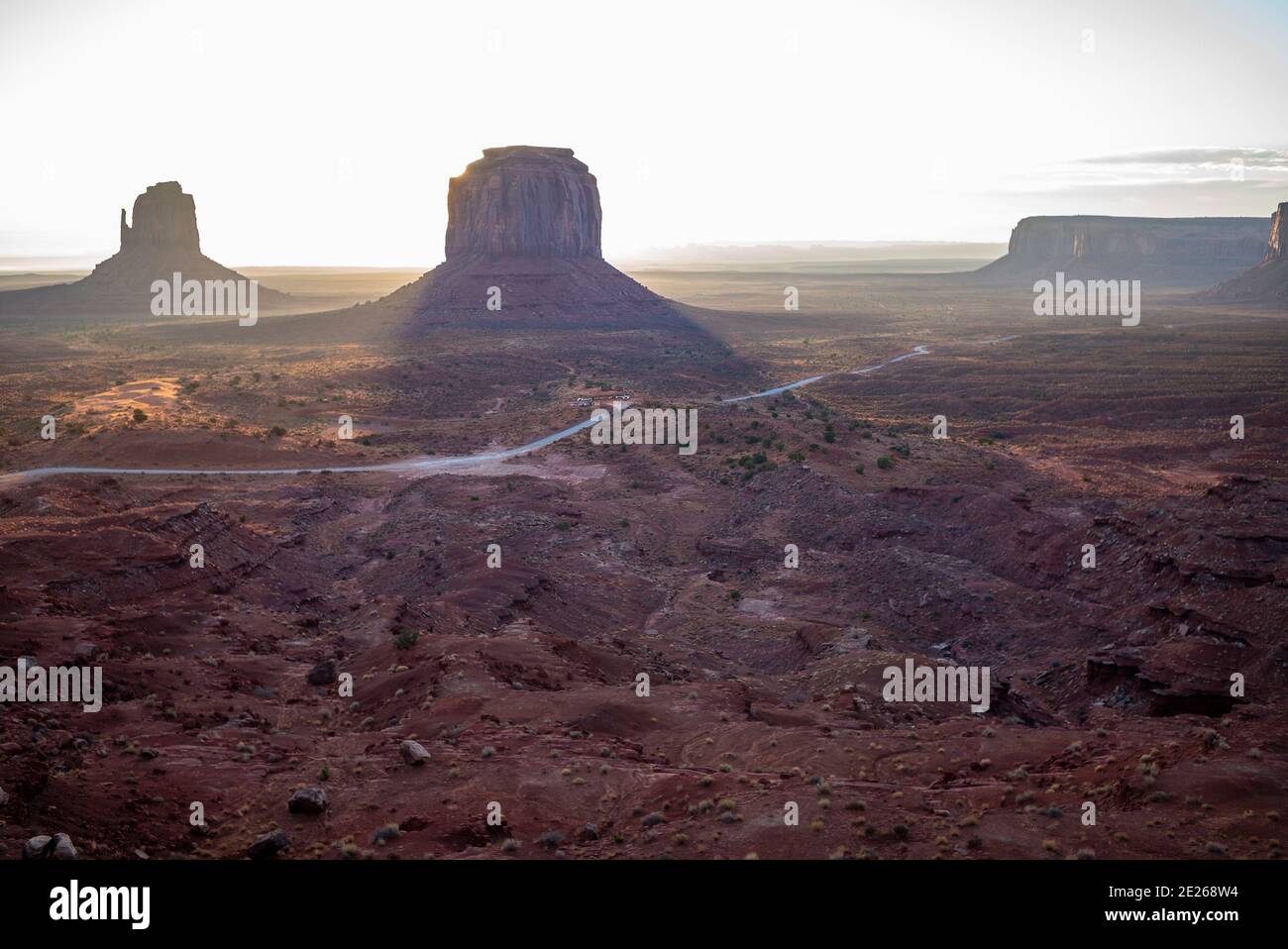 The East Mitten and Merrick Butte rock formations and road at sunrise ...