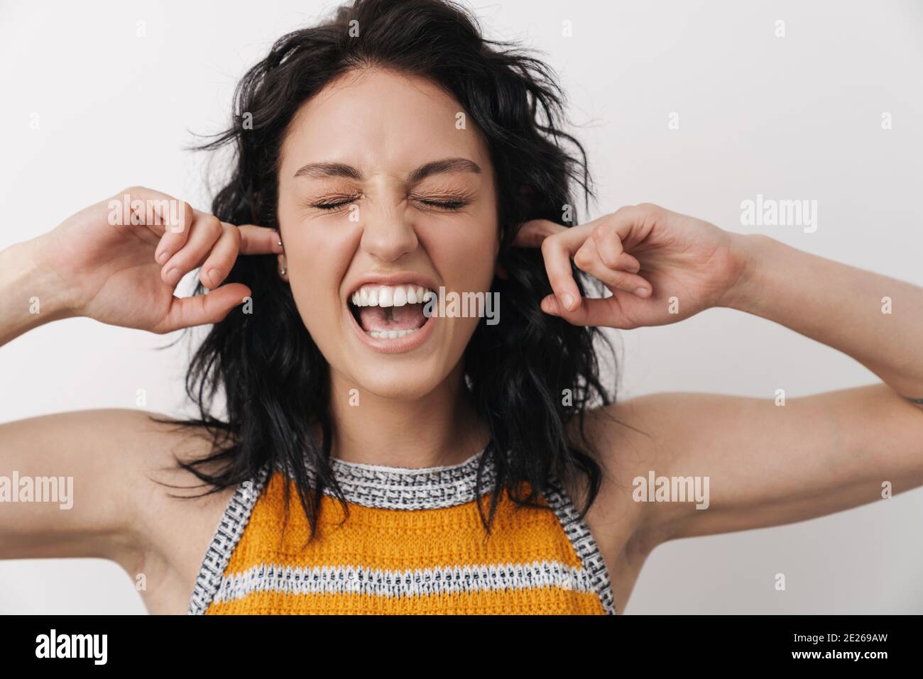 Beautiful young screaming woman isolated over white wall background ...