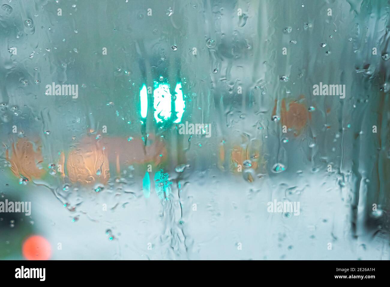 Drops from snow and rain flow down the windshield. Poor visibility on ...