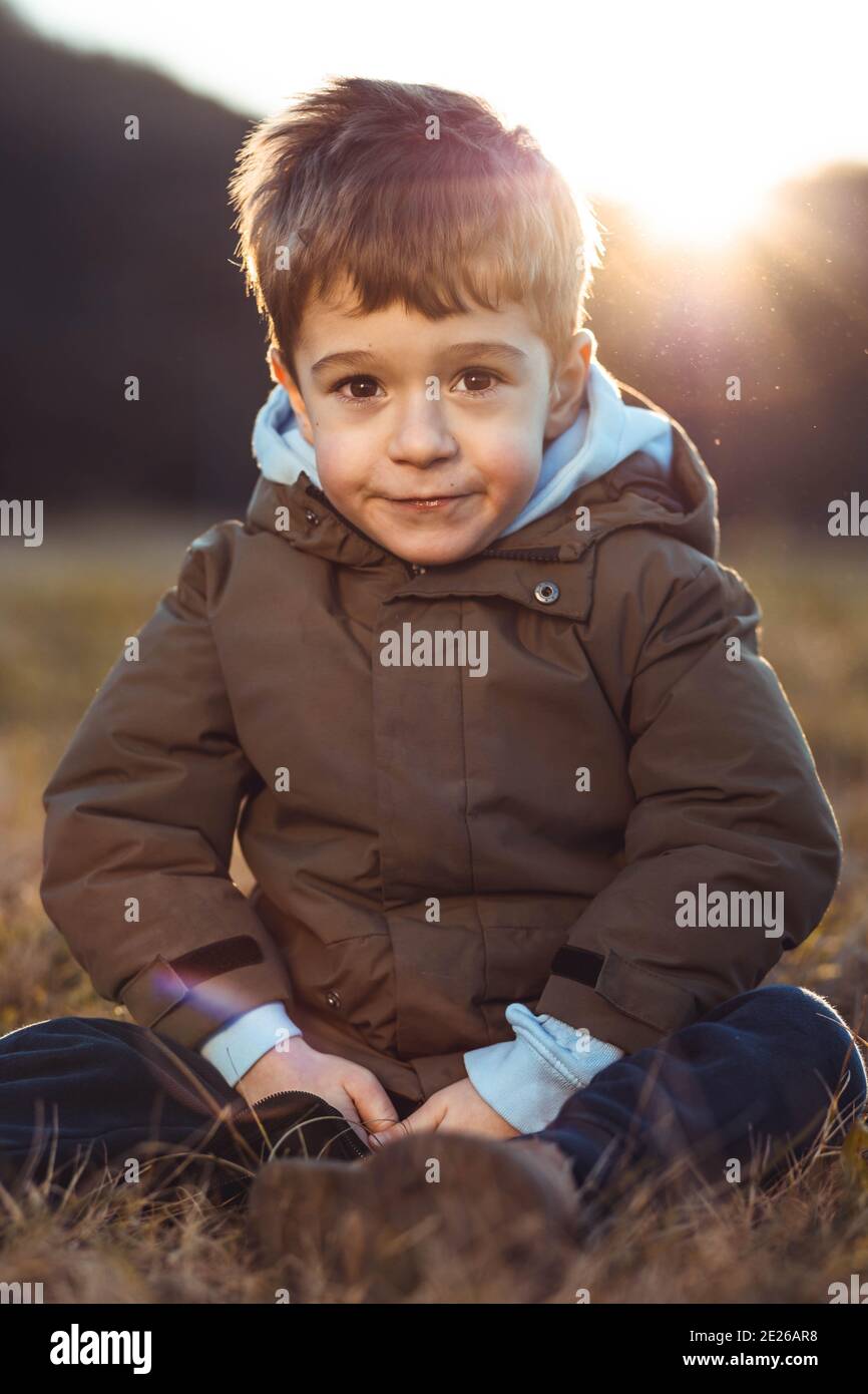 Portrait of a cute, little boy smiling timidly Stock Photo - Alamy