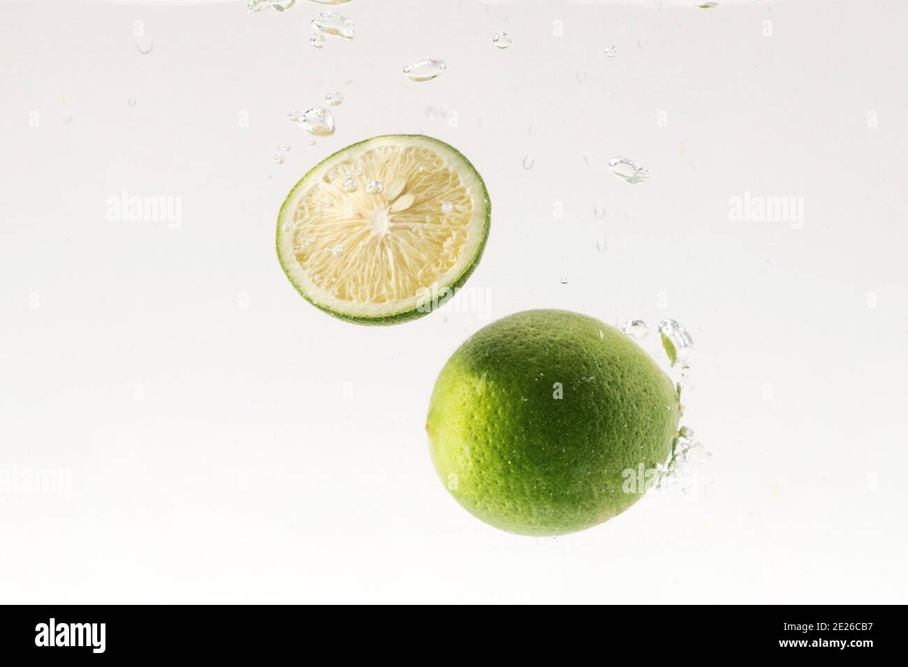 Lime floating in water on white background Stock Photo - Alamy