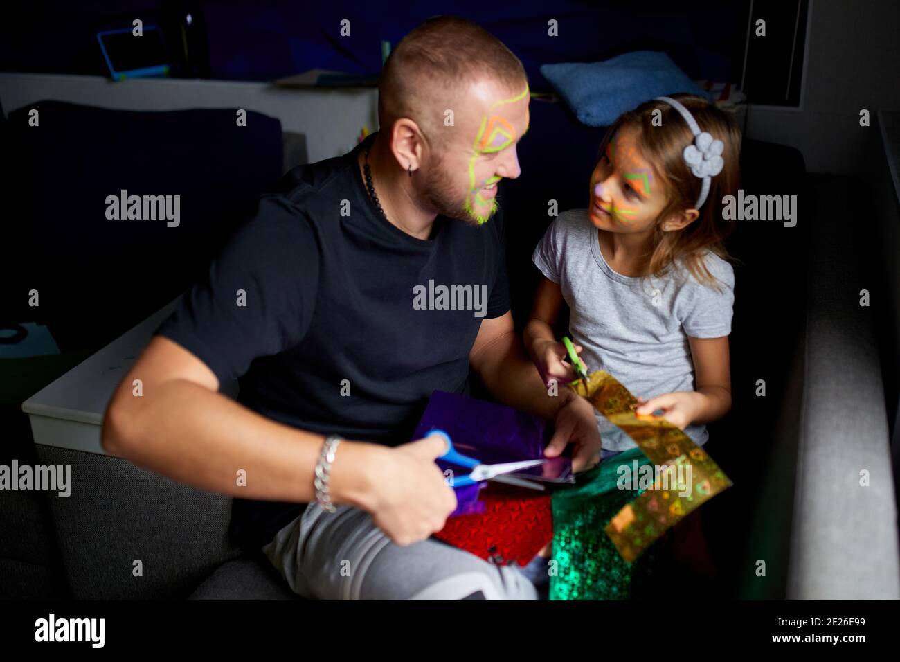 Daughter and father having fun making craft together at home on the ...