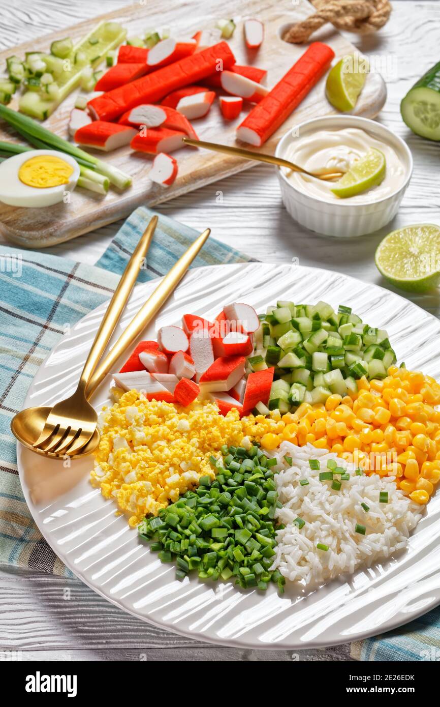 Crab salad of surimi sticks with canned corn, cucumbers, spring onion ...
