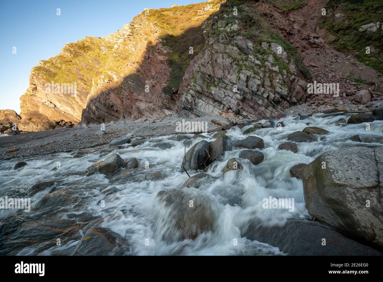 Long exposure of the river Heddon flowing onto the beach at Heddons ...