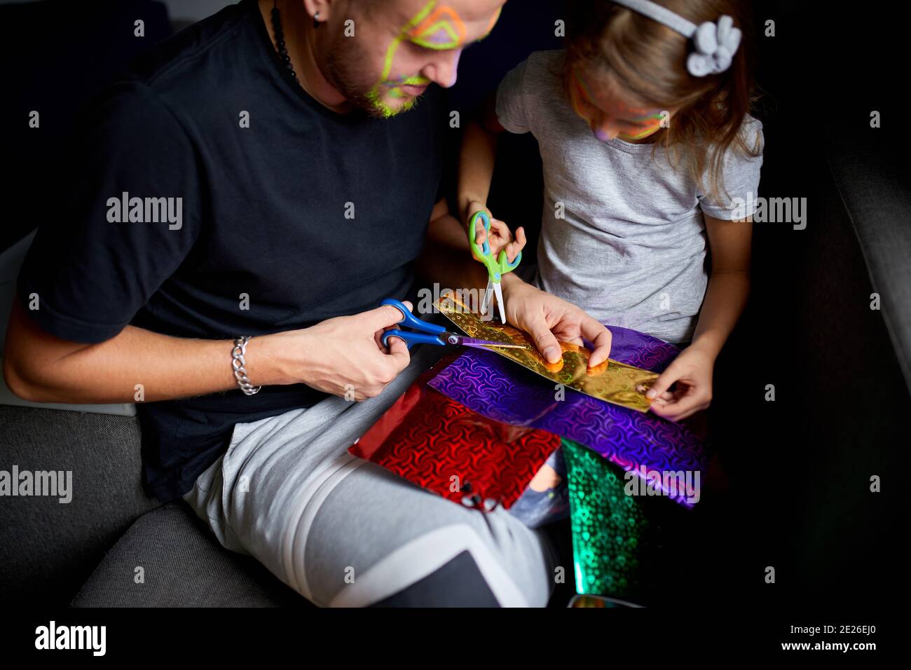 Daughter and father having fun making craft together at home on the ...