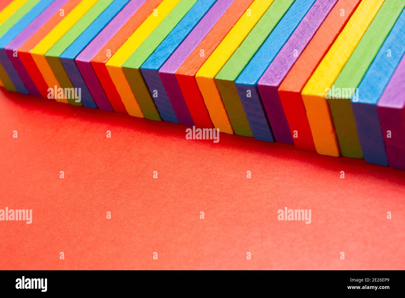 Colorful dominoes. Rainbow colored chain reaction Stock Photo - Alamy