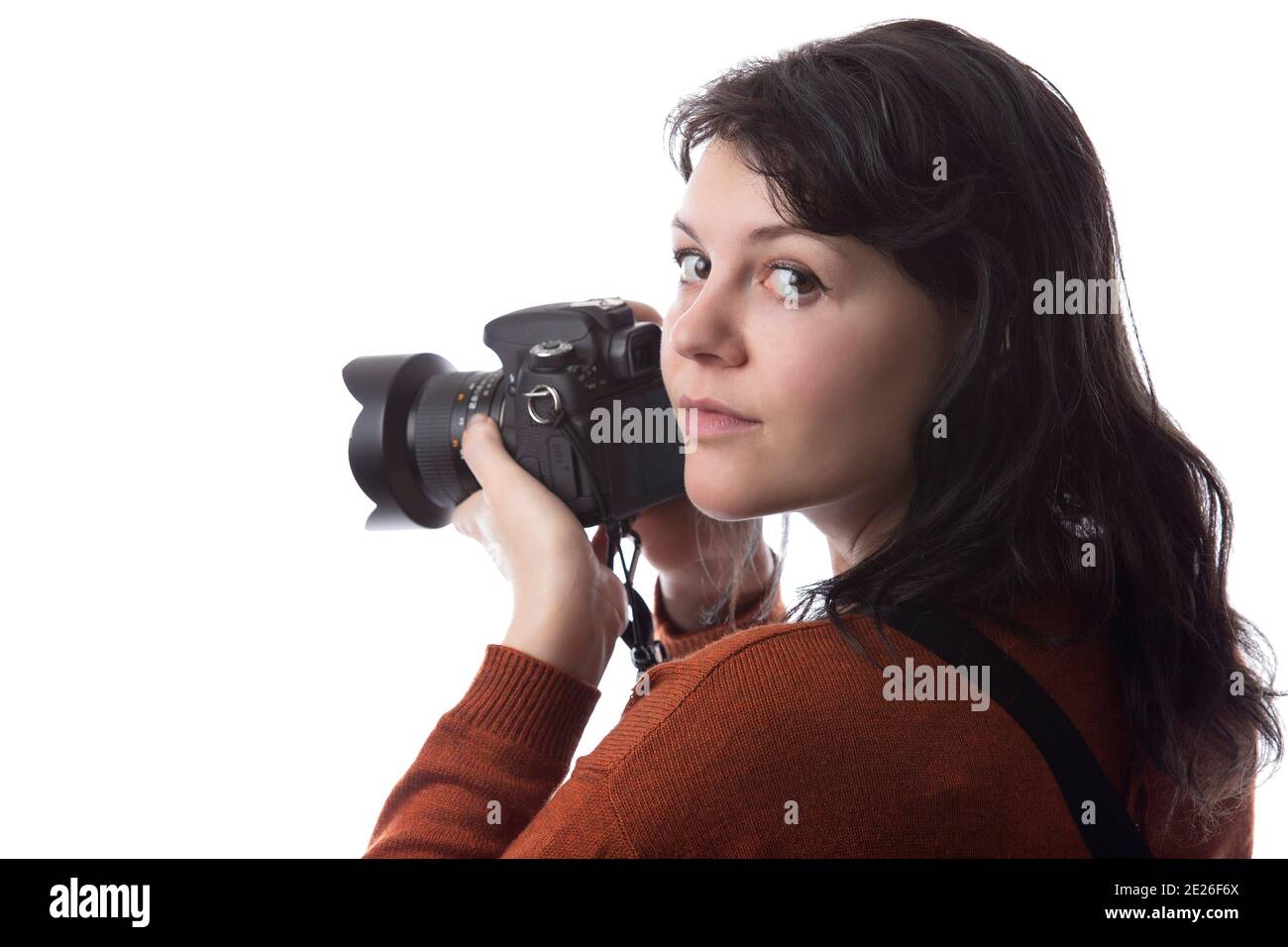 Side view of a female photographer holding a camera isolated on a white ...