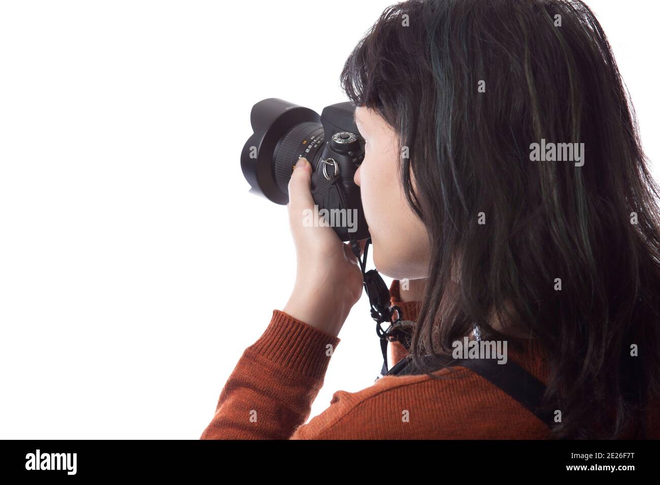 Side view of a female photographer holding a camera isolated on a white ...