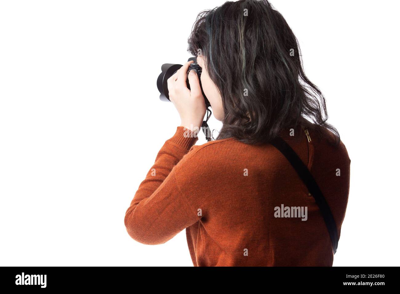 Side view of a female photographer holding a camera isolated on a white ...