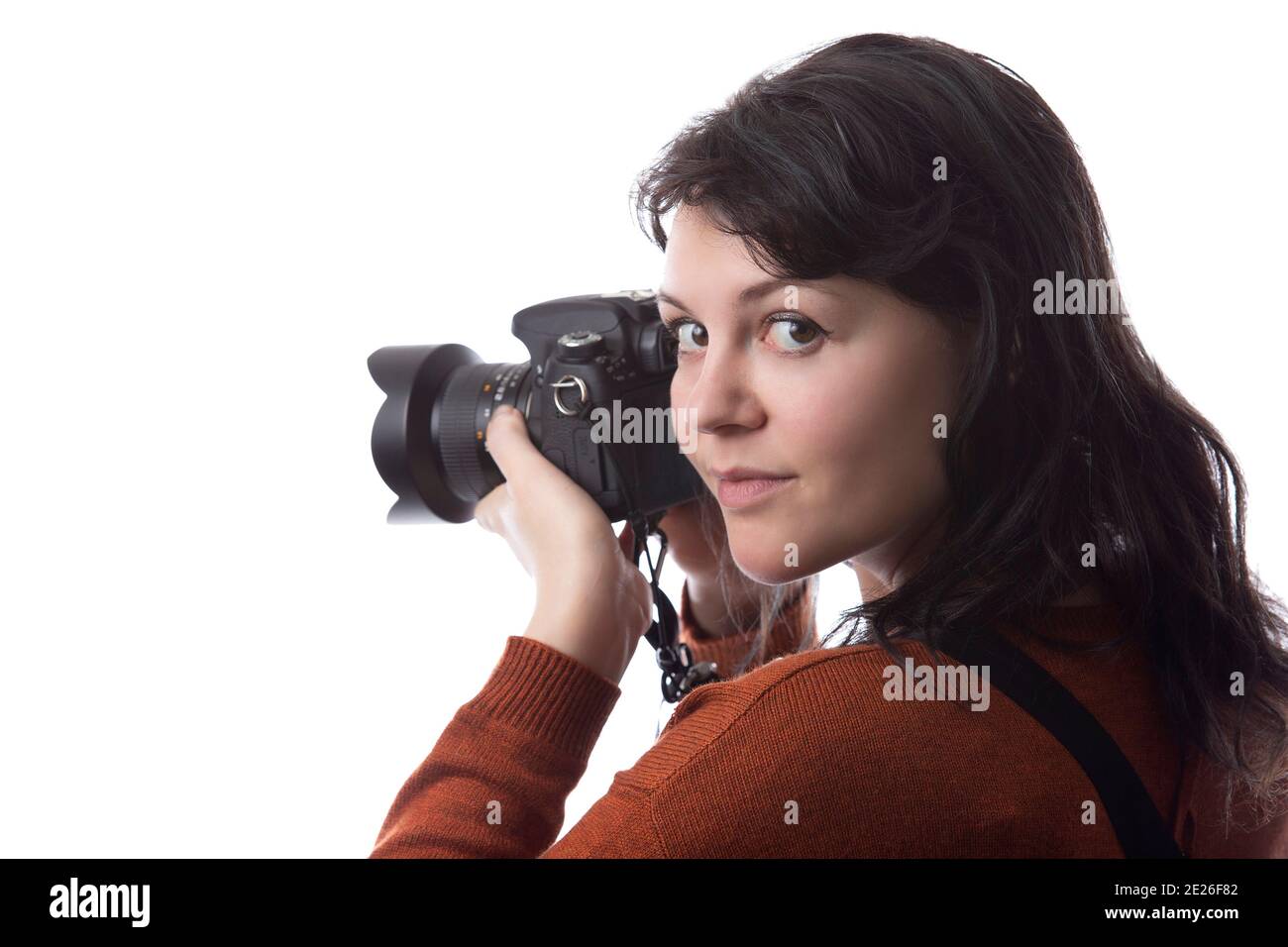 Side view of a female photographer holding a camera isolated on a white ...