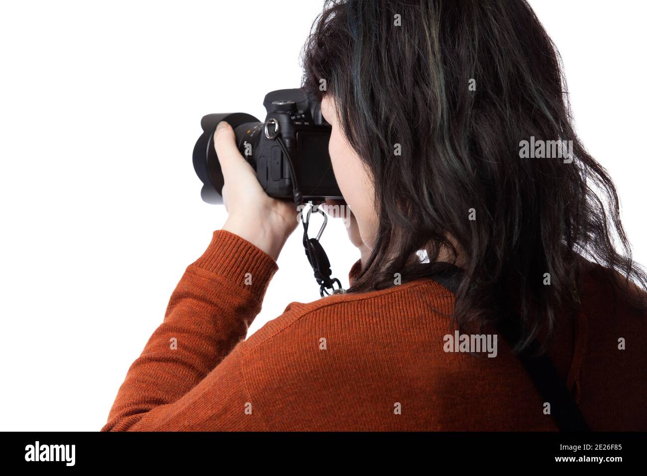 Side view of a female photographer holding a camera isolated on a white ...