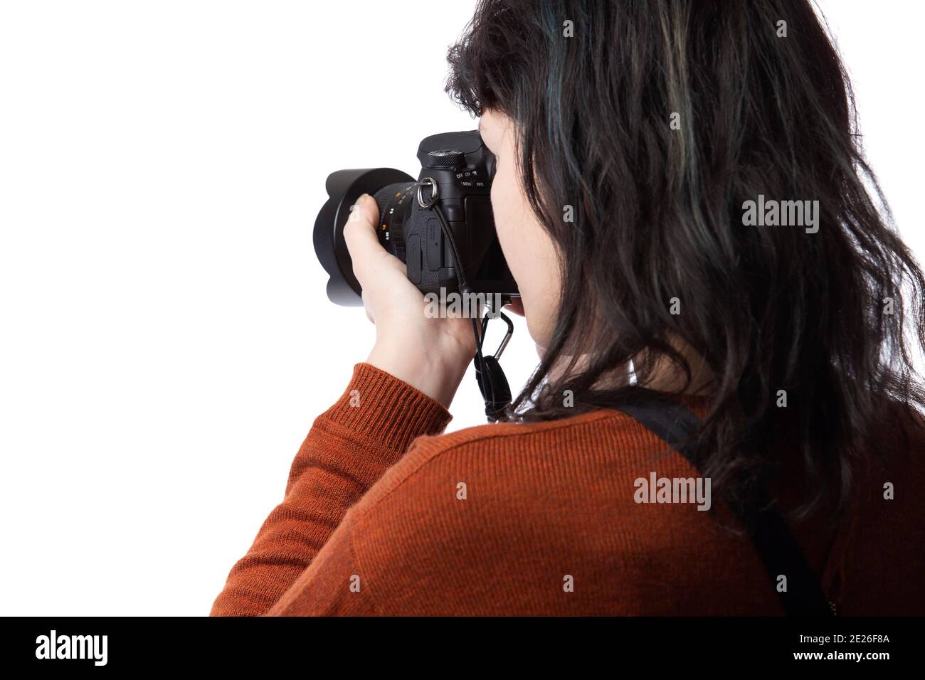 Side view of a female photographer holding a camera isolated on a white ...