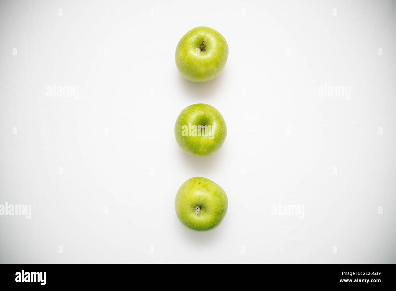 Top view of three green apples on a white background Stock Photo - Alamy