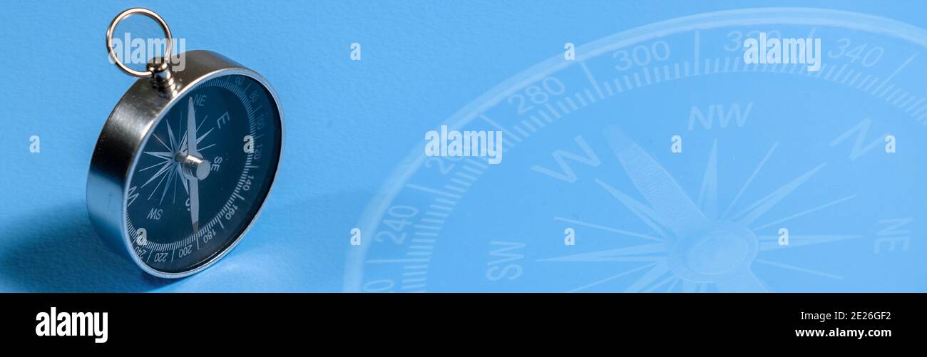 Compass on blue background with copy space. Direction concept. Banner ...