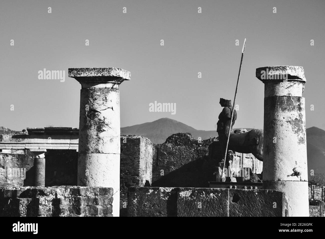 Pompeii. Forum ruins with centaur statue and mountains and sky at ...