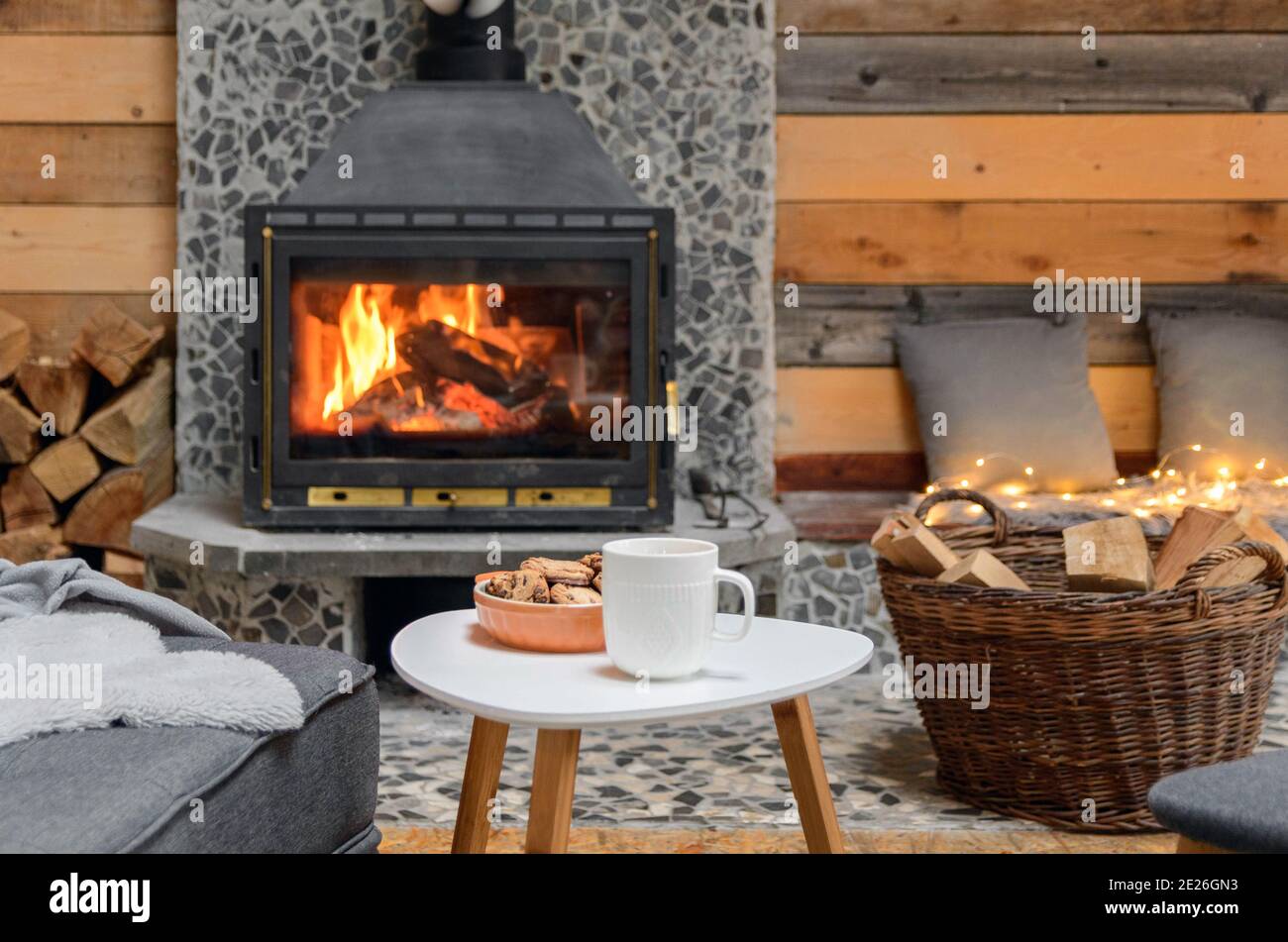 Cozy cabin interior with a burning fireplace Stock Photo - Alamy