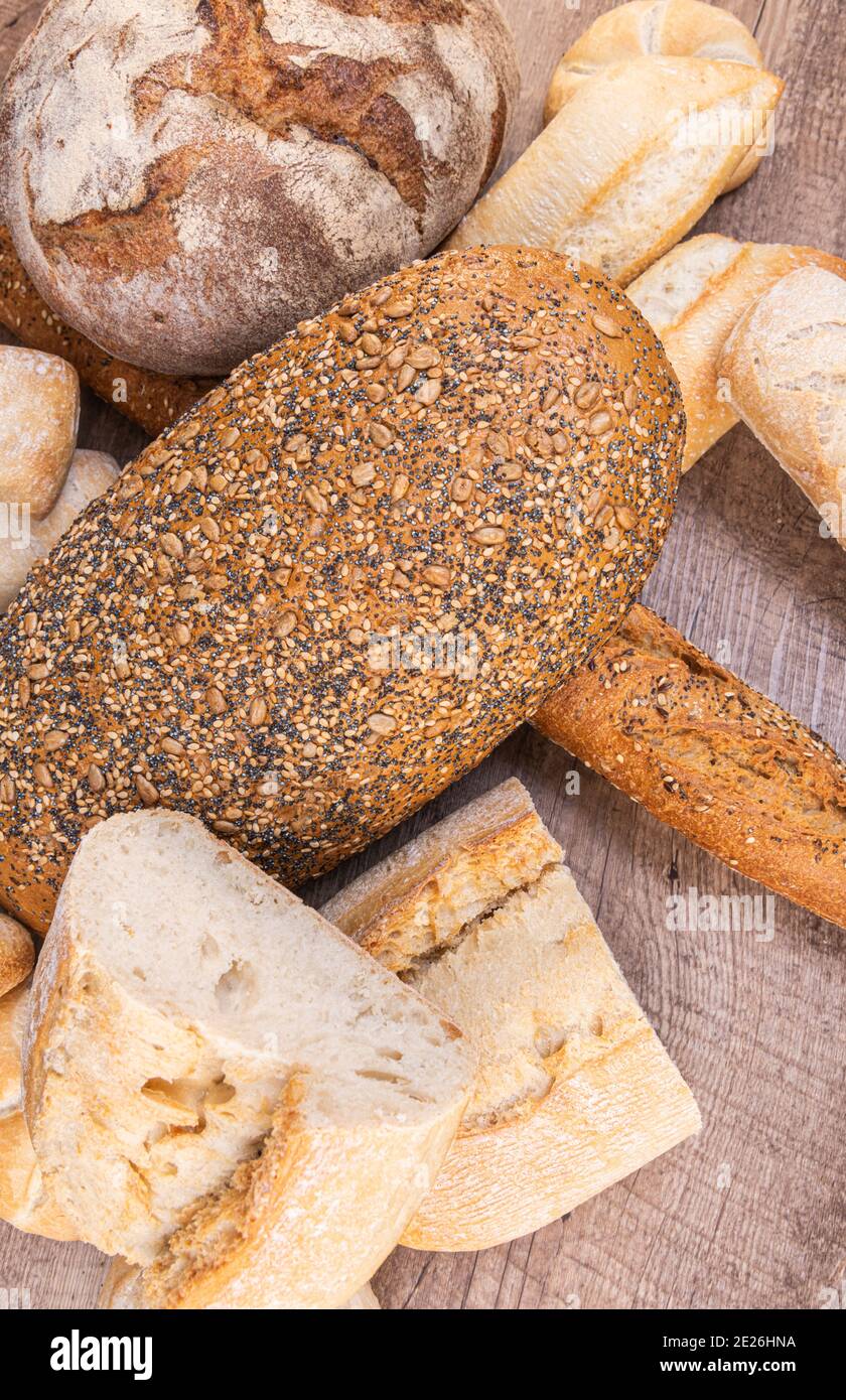 Top view of a variety of bread loaves on a wooden surface Stock Photo ...
