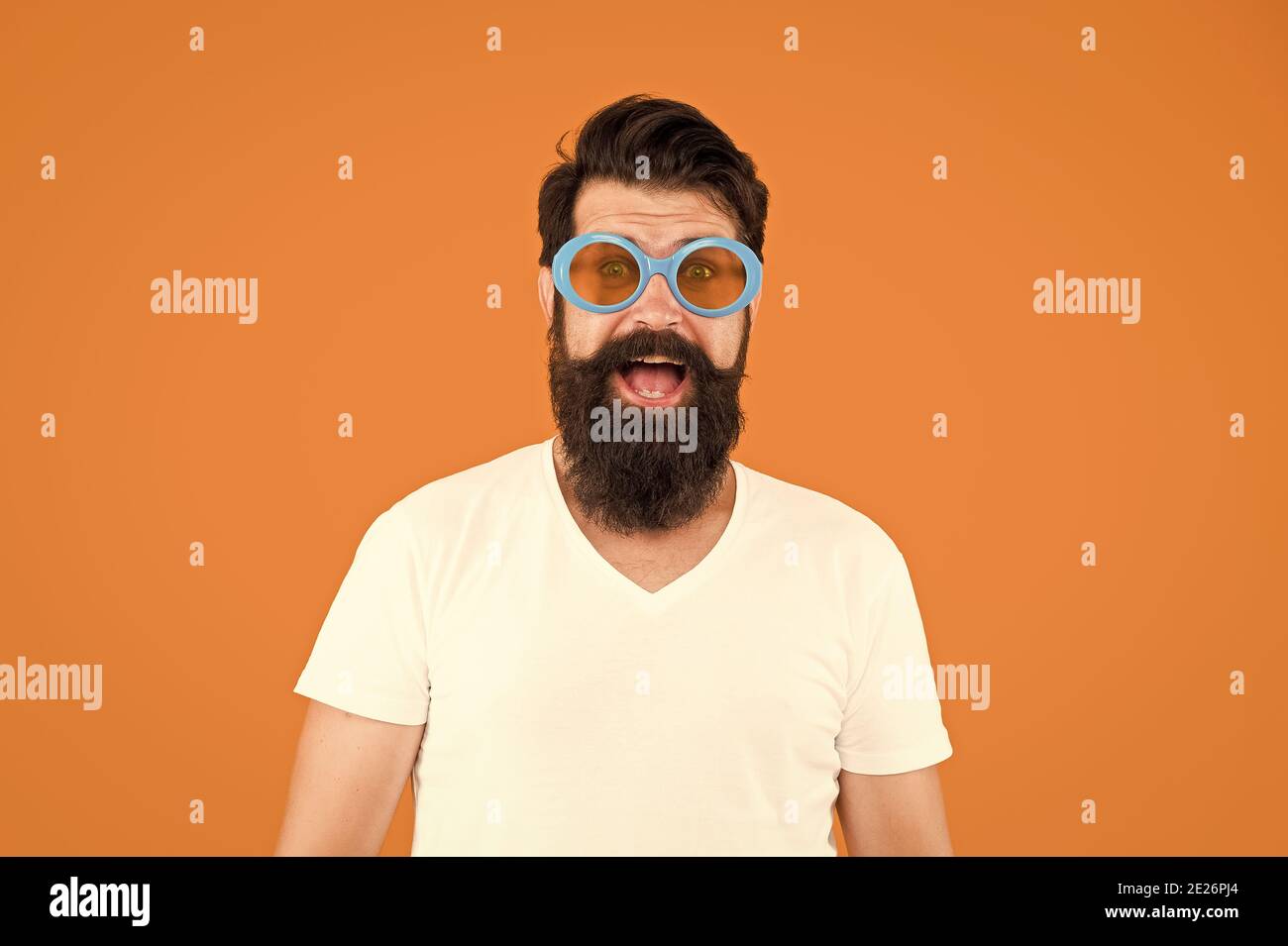 Perfect glasses for perfect party. Party man orange background. Bearded ...