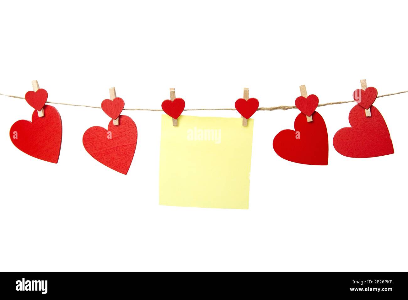 Blank yellow sticky note hanging with red hearts isolated on white ...