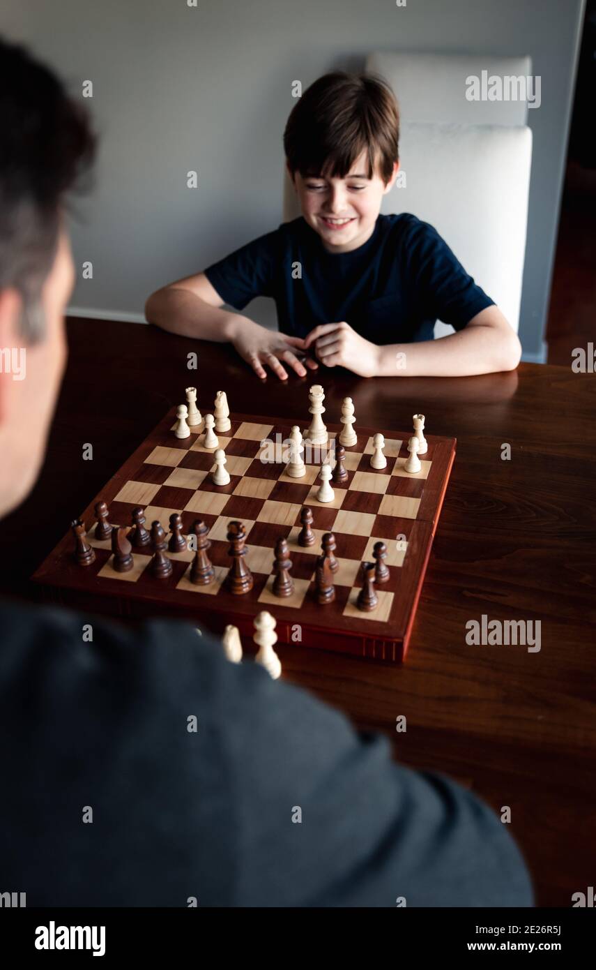 Father and son play chess hi-res stock photography and images - Alamy