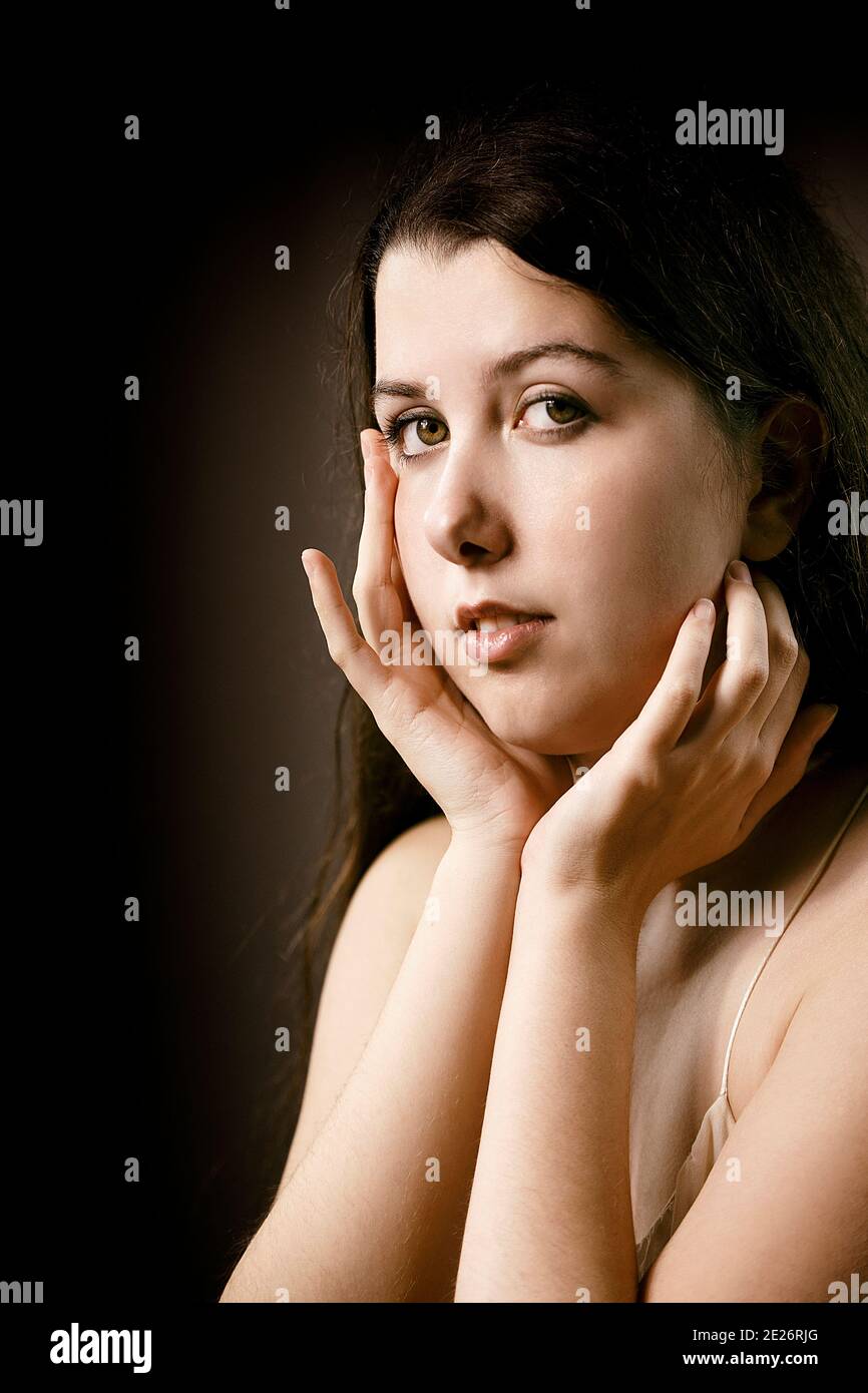 beautiful teenager caressing her face Stock Photo - Alamy