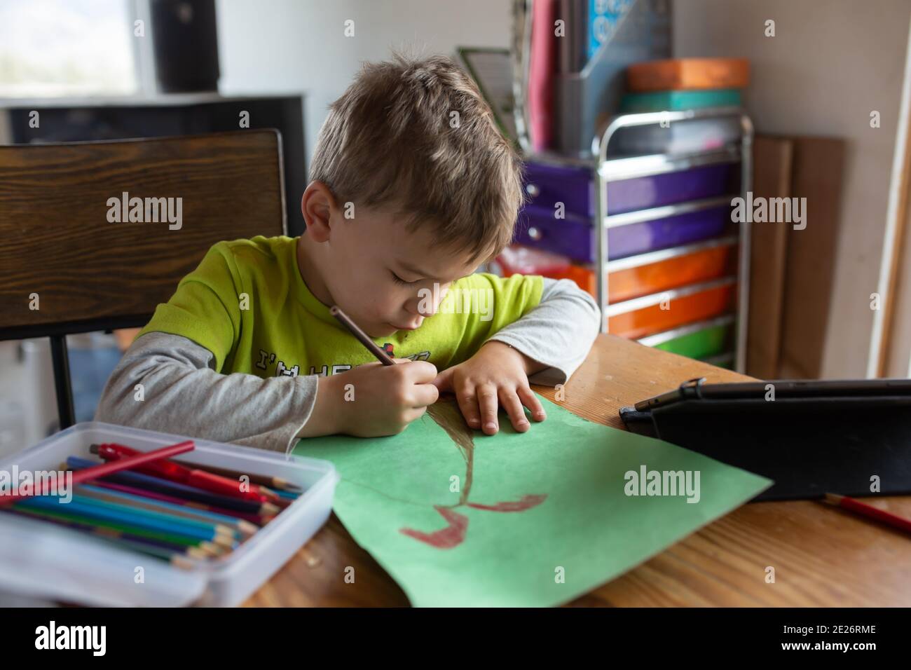 Boy focused as he creates art at home Stock Photo - Alamy