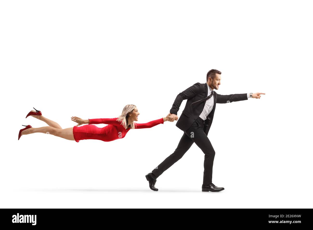 Man in a suit running and pulling a woman in a red dress isolated on ...