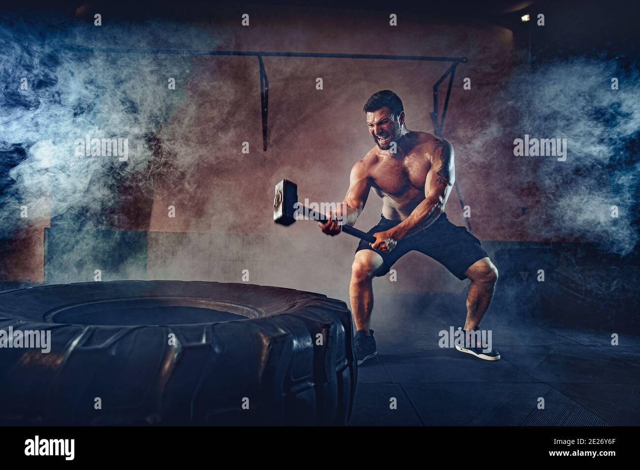 Sports training for endurance, man hits hammer. Concept workout Stock ...