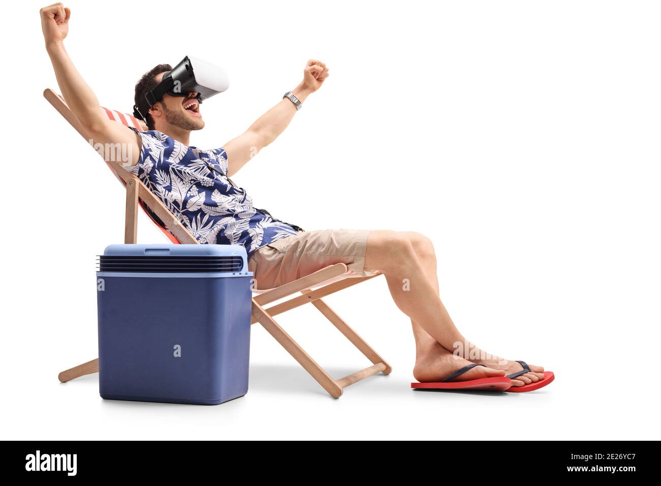 Man on a deck chair with a VR headset gesturing happiness isolated on ...