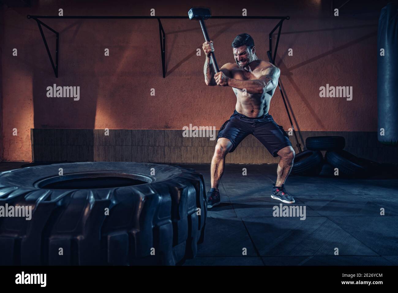 Sports training for endurance, man hits hammer. Concept workout Stock ...