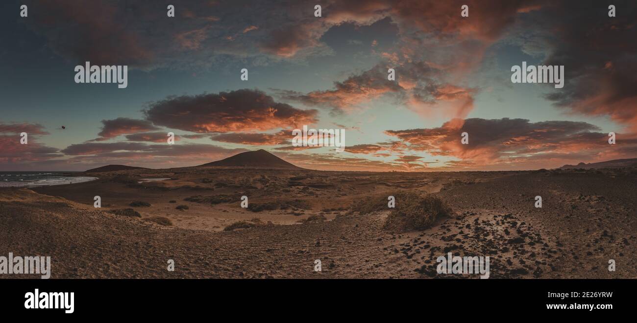 sunset landscape with warm colors where you can see a mountain and ...