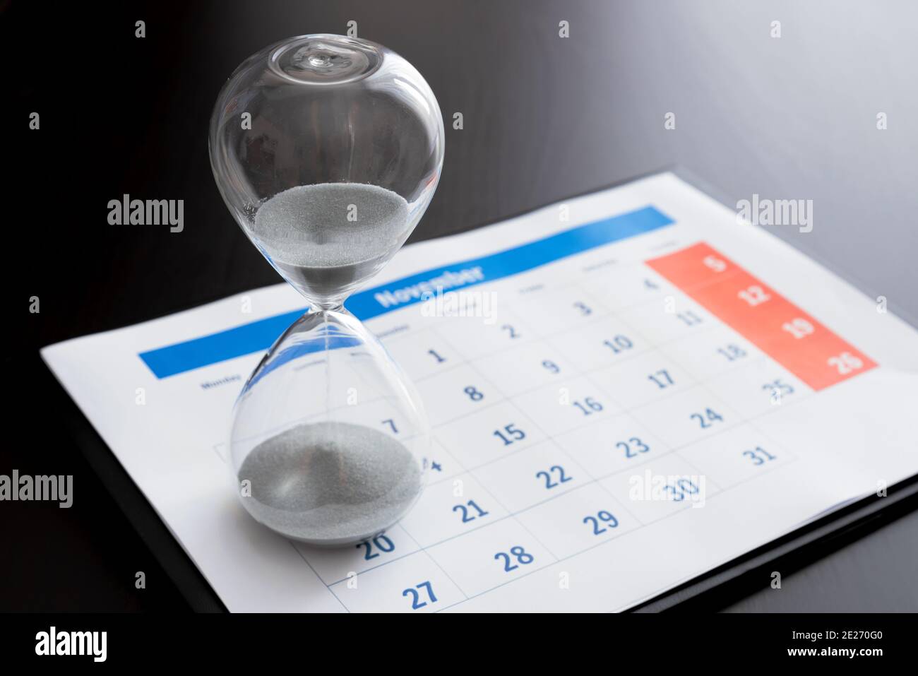 Time passing concept, time slipping away. Hourglass and the calendar ...