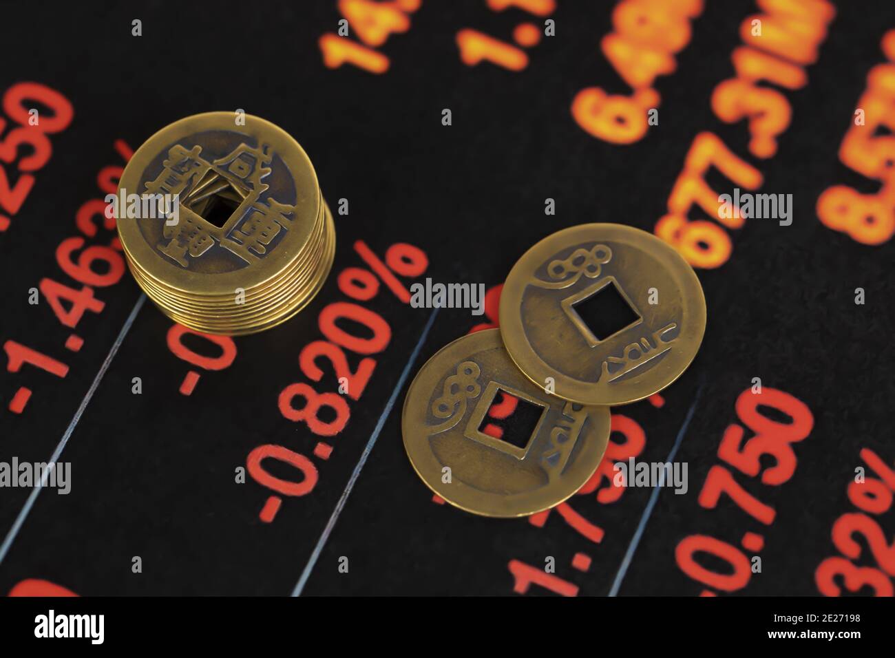 Coins on digital stock market graph Stock Photo - Alamy
