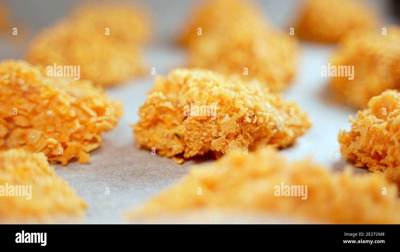 Chicken nuggets on parchment paper before baking Stock Photo - Alamy