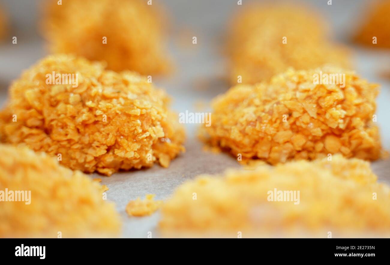 Chicken nuggets on parchment paper before baking Stock Photo - Alamy